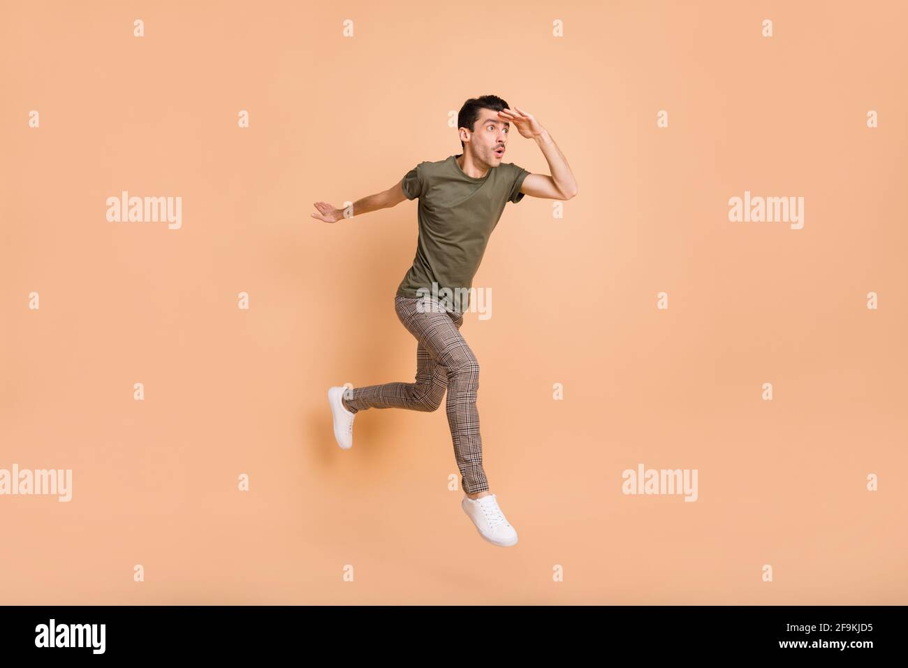 Full length body size photo of jumping high man looking forward far ...