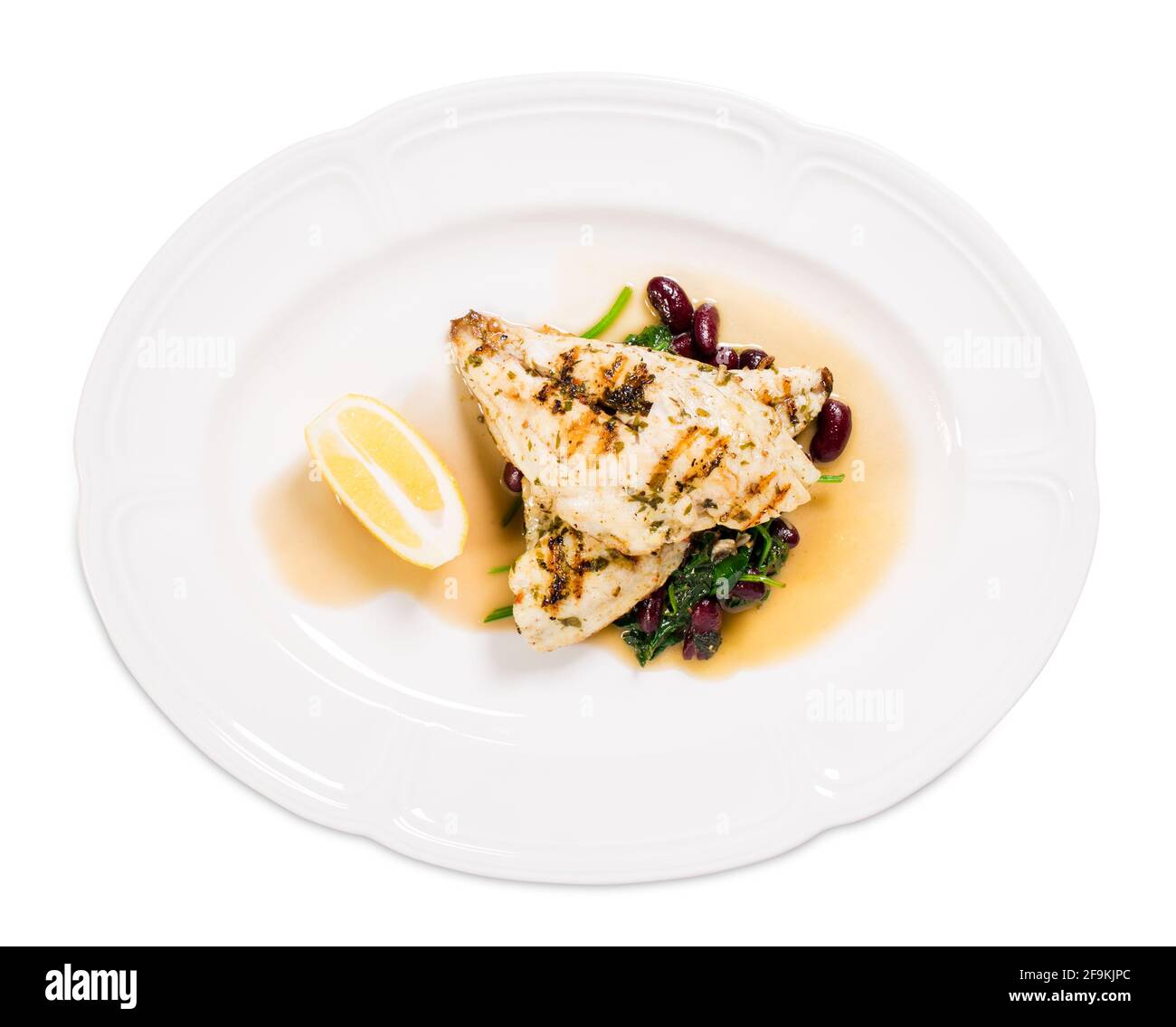 Delicious dorado fillet with chard and beans. Isolated on a white ...