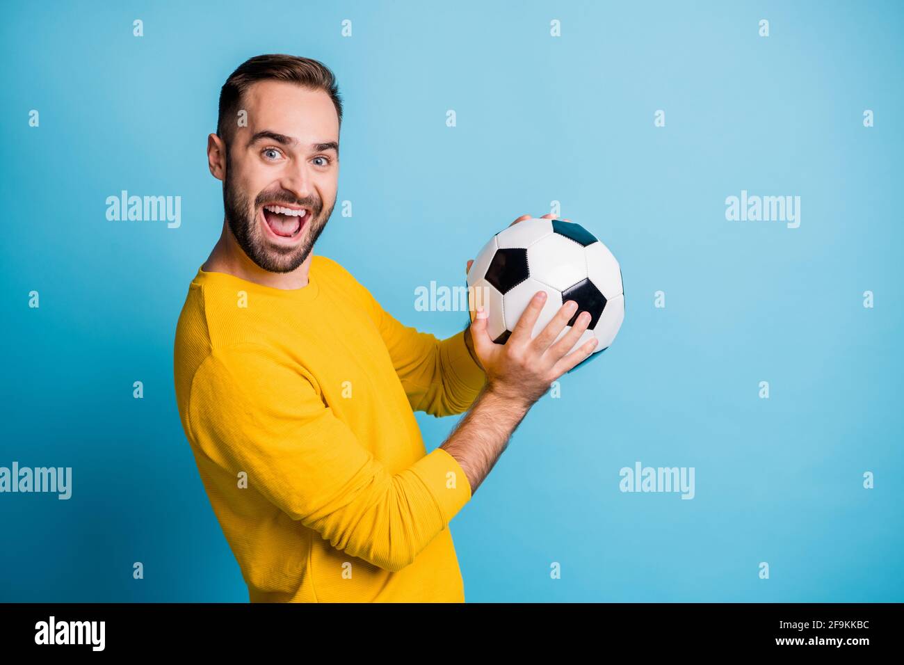 Photo portrait of man with ball smiling laughing in yellow clothes ...