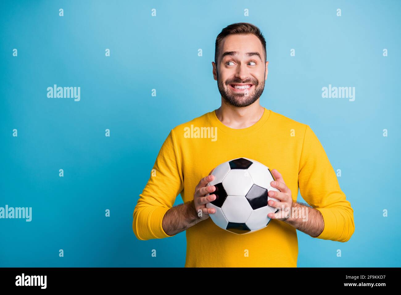 Photo portrait of man with ball smiling looking blank space curious ...
