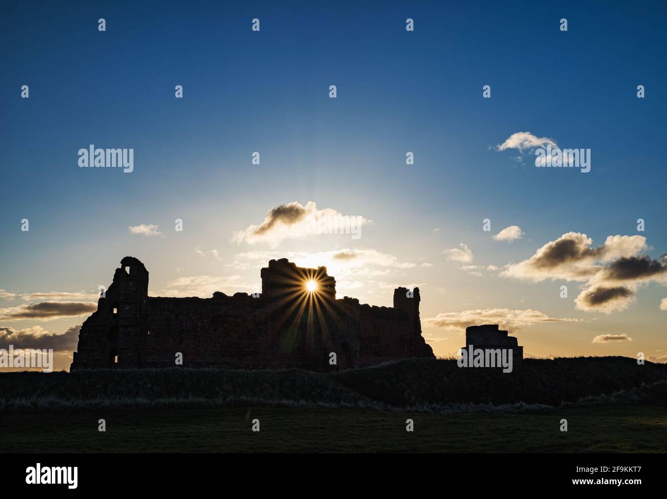 Sunrise at dawn over ruined Tantallon Medieval castle with sunburst and ...