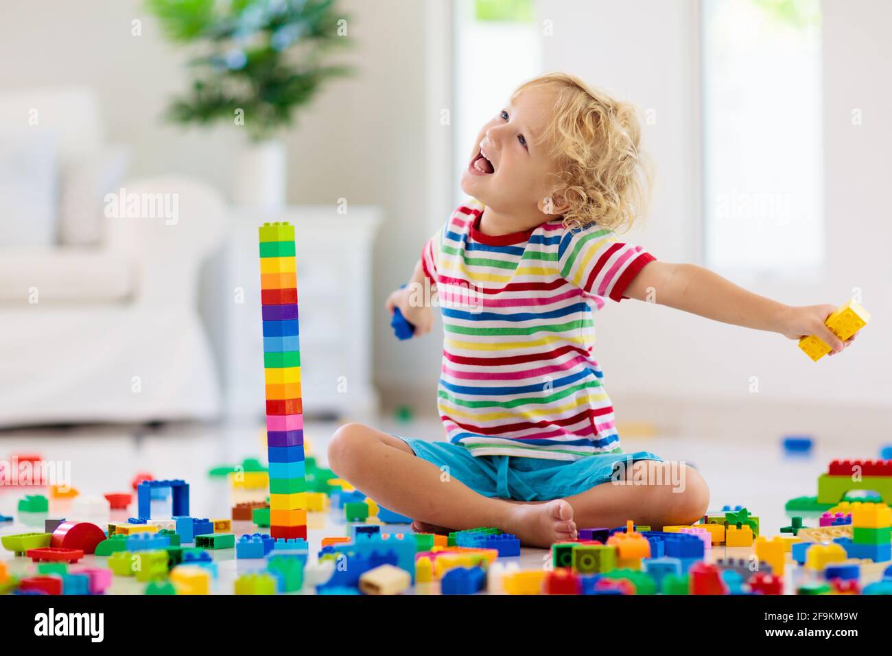 Child playing with colorful toy blocks. Little boy building tower at ...