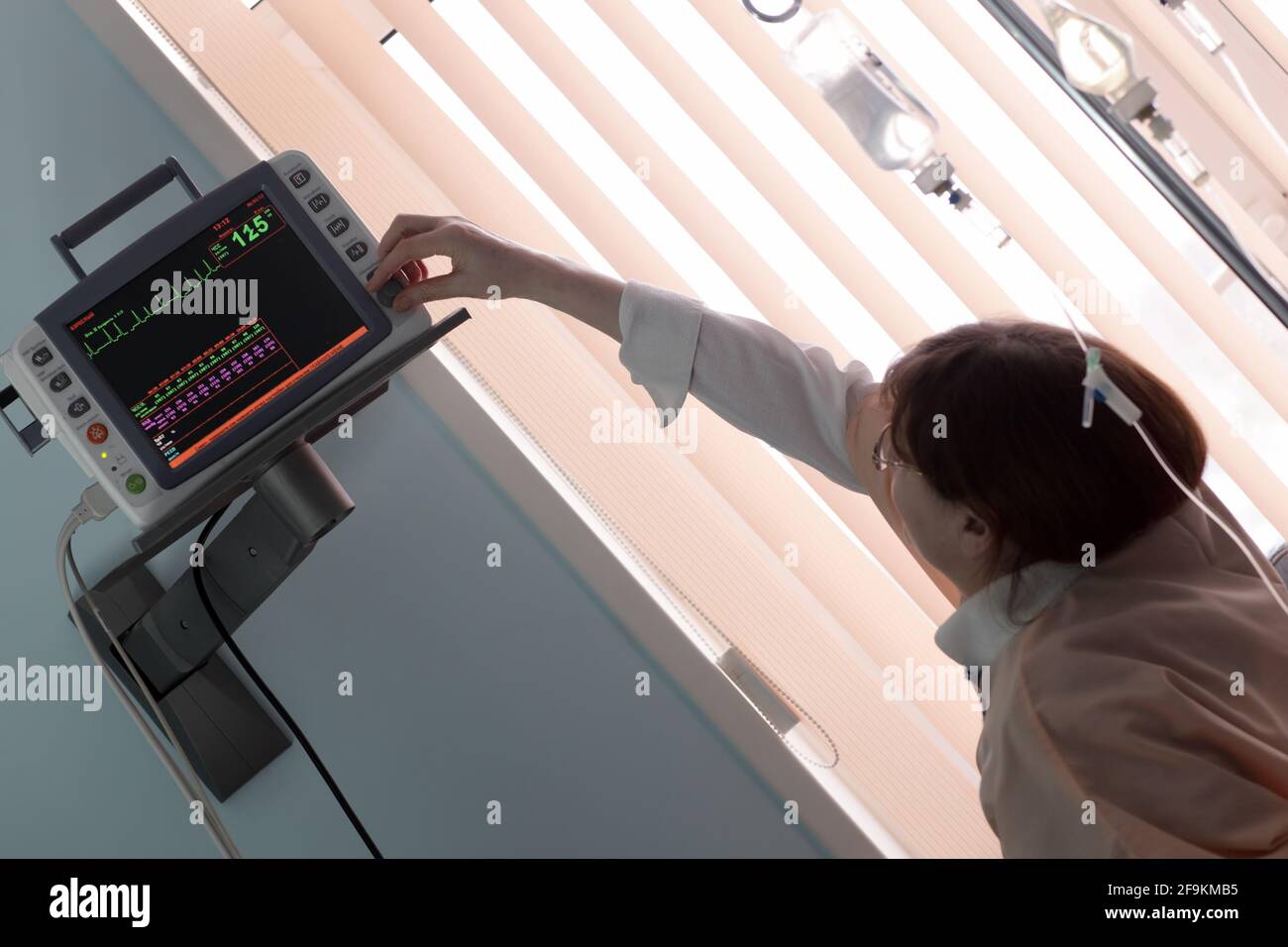 Nurse is tuning patient monitor in a hospital ward Stock Photo - Alamy