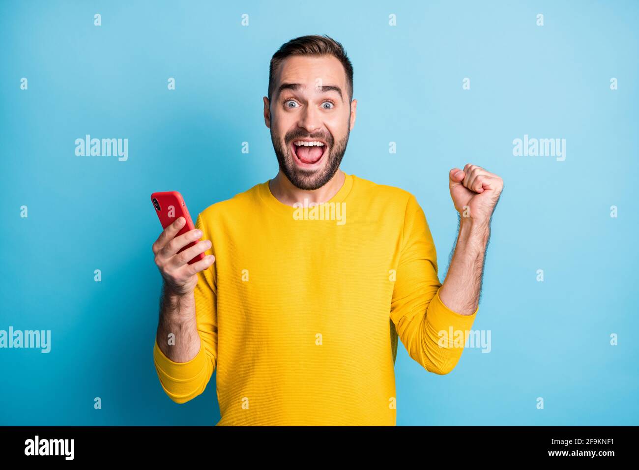 Photo of young handsome excited crazy smiling man raise fist in victory ...