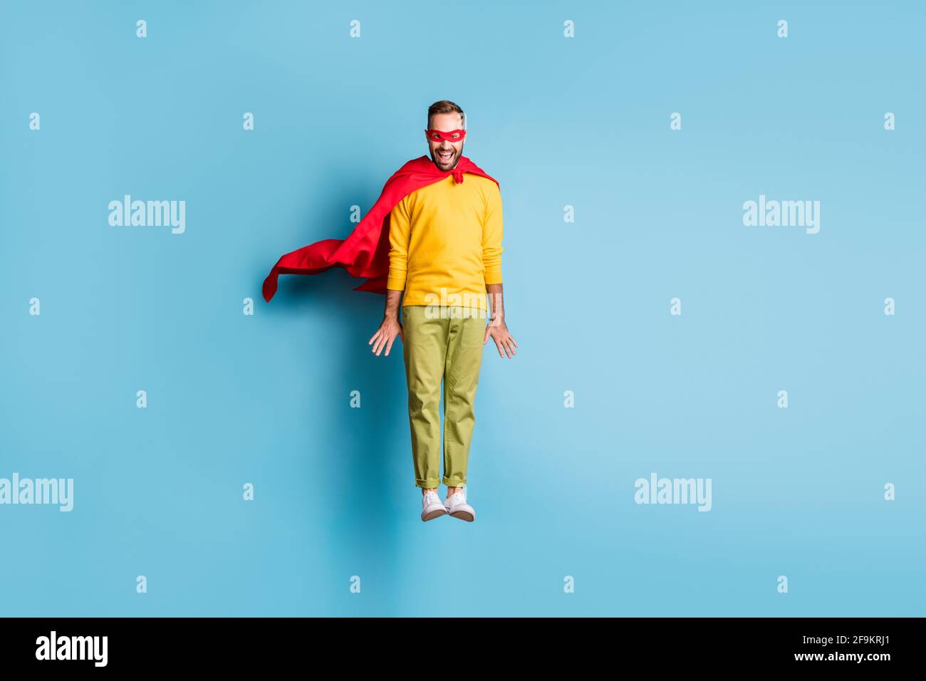 Full length body size photo of superhero in mantle mask jumping high ...