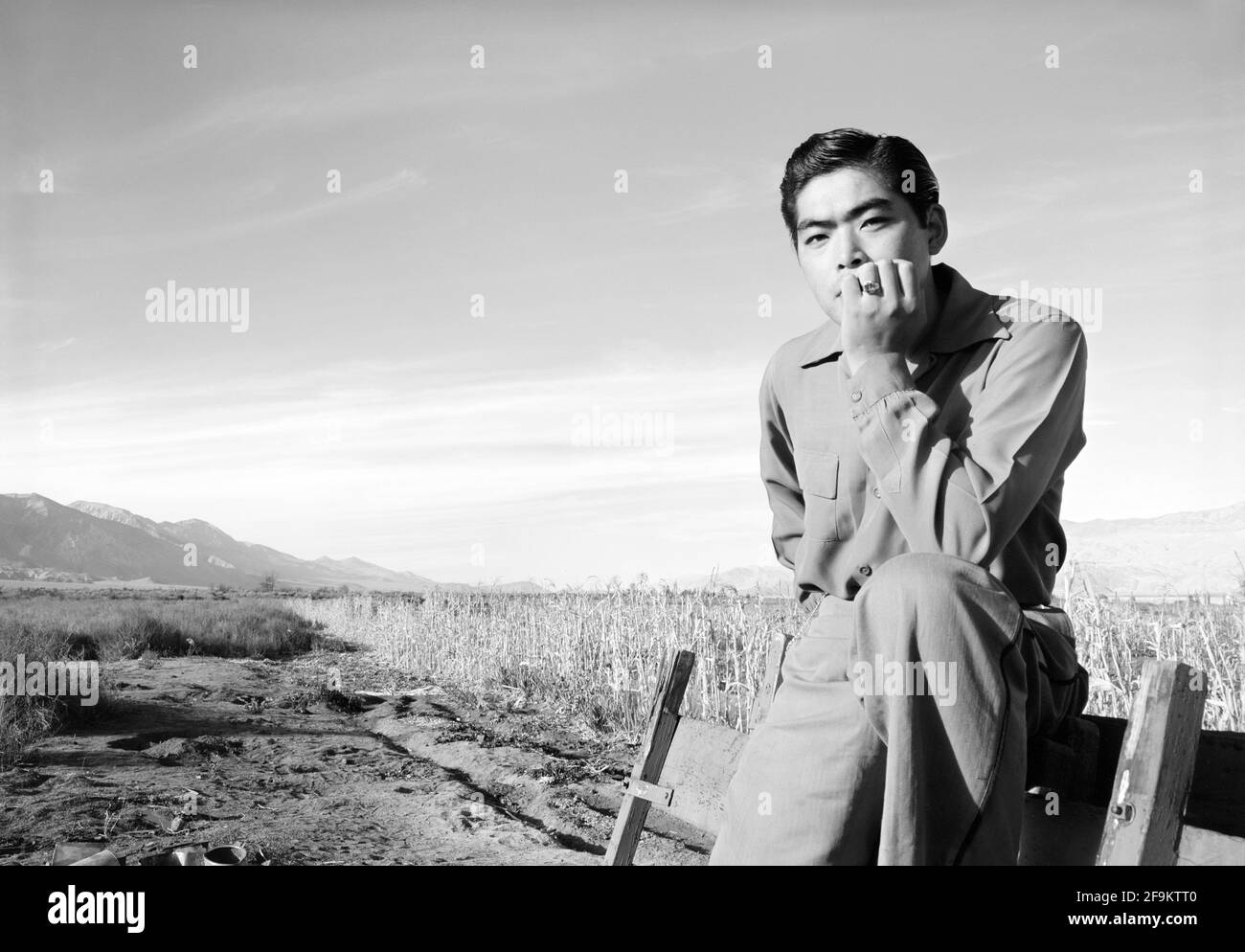 Tom Kobayashi, seated Portrait in Field, Manzanar Relocation Center ...