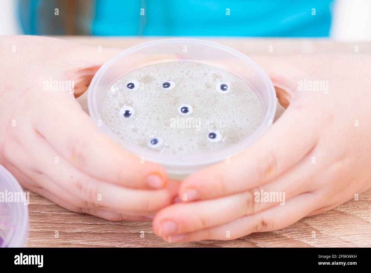 White transparent mucus on the hands of the child. The child plays ...