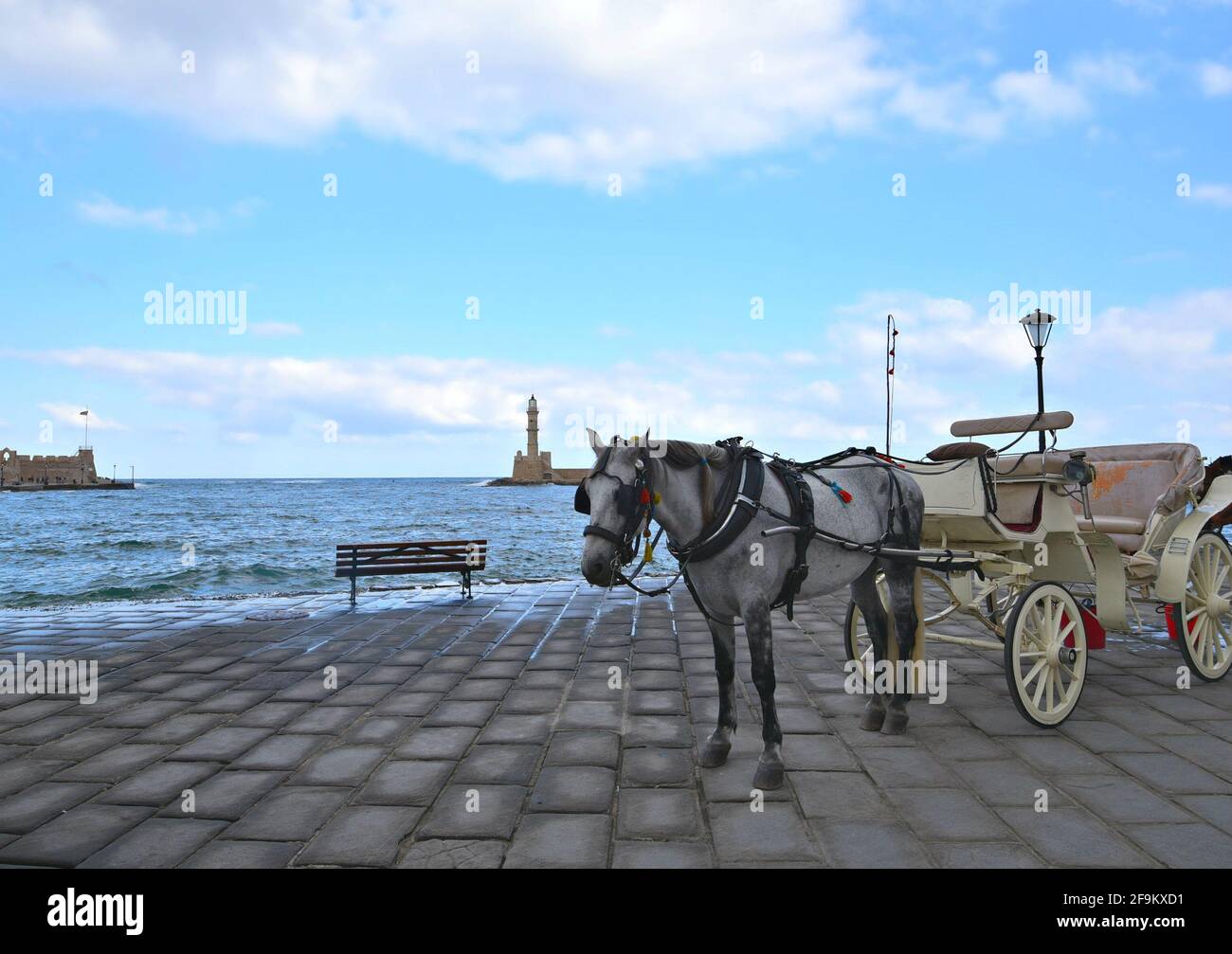 Horse carriage at the Old Venetian harbor of Chania in Crete island ...