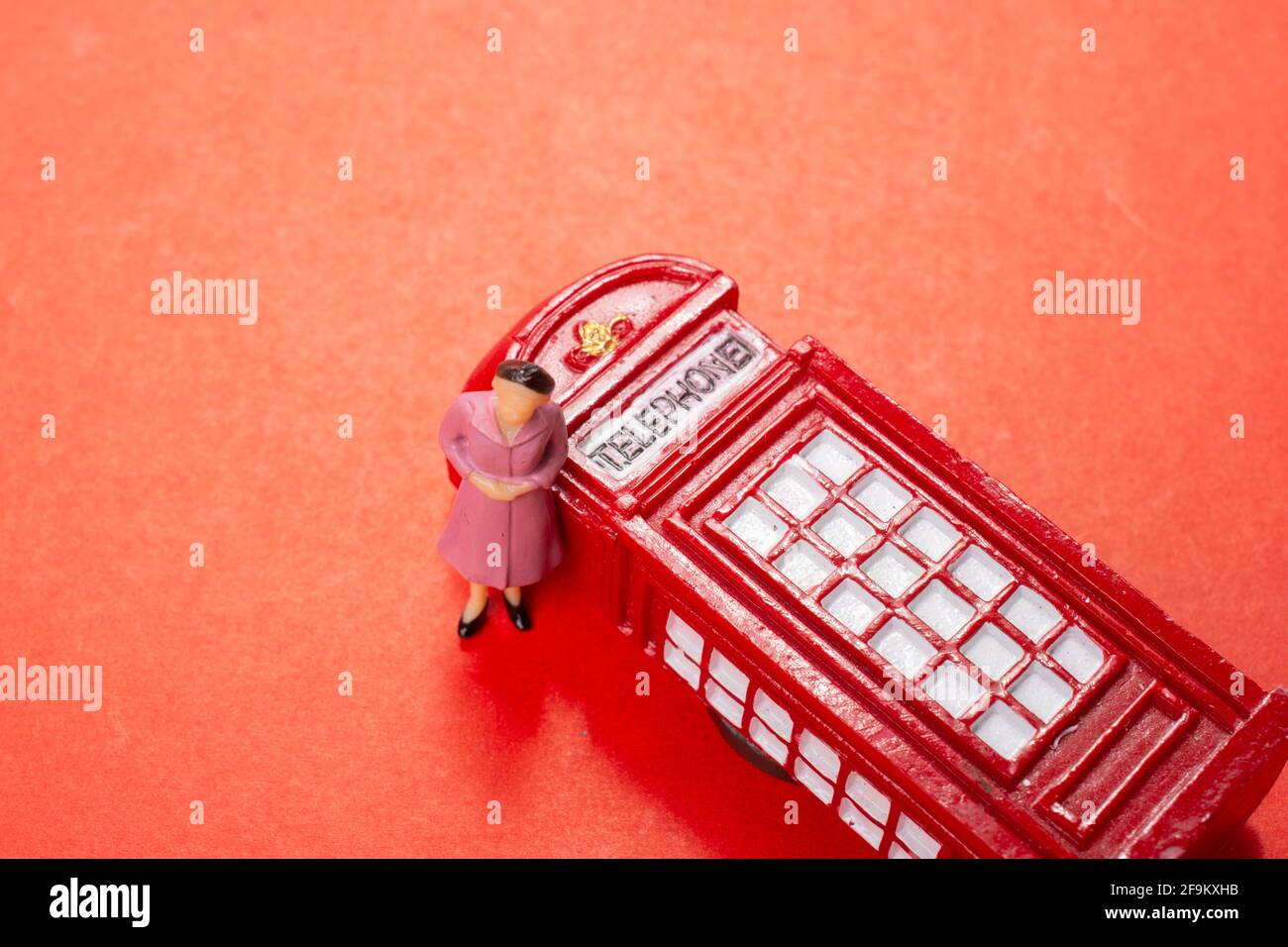 Classical British style Red phone booth model and woman figurine on red ...