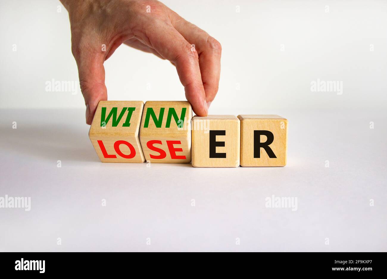 Loser or winner symbol. Businessman turns cubes and changes the word ...