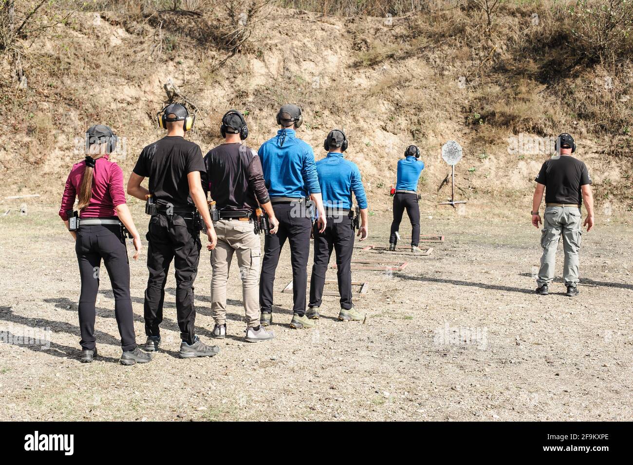 Young people on tactical gun training classes. Shooting and Weapons ...