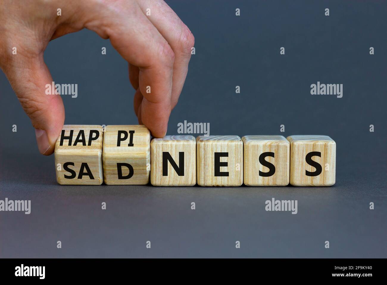 Happiness or sadness symbol. Businessman turns cubes and changes the ...