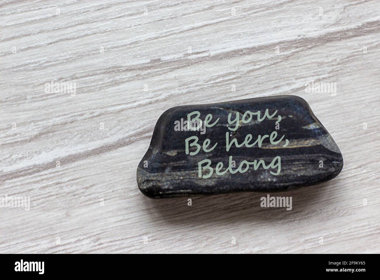 Be here, be you, belong symbol. Beautiful stone with words 'Be here, be ...