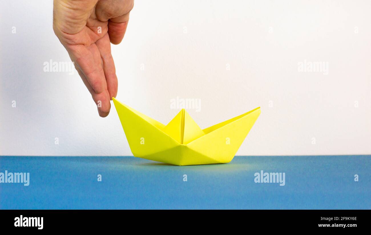 Image of businessman pushing paper made origami boat forward in a ...