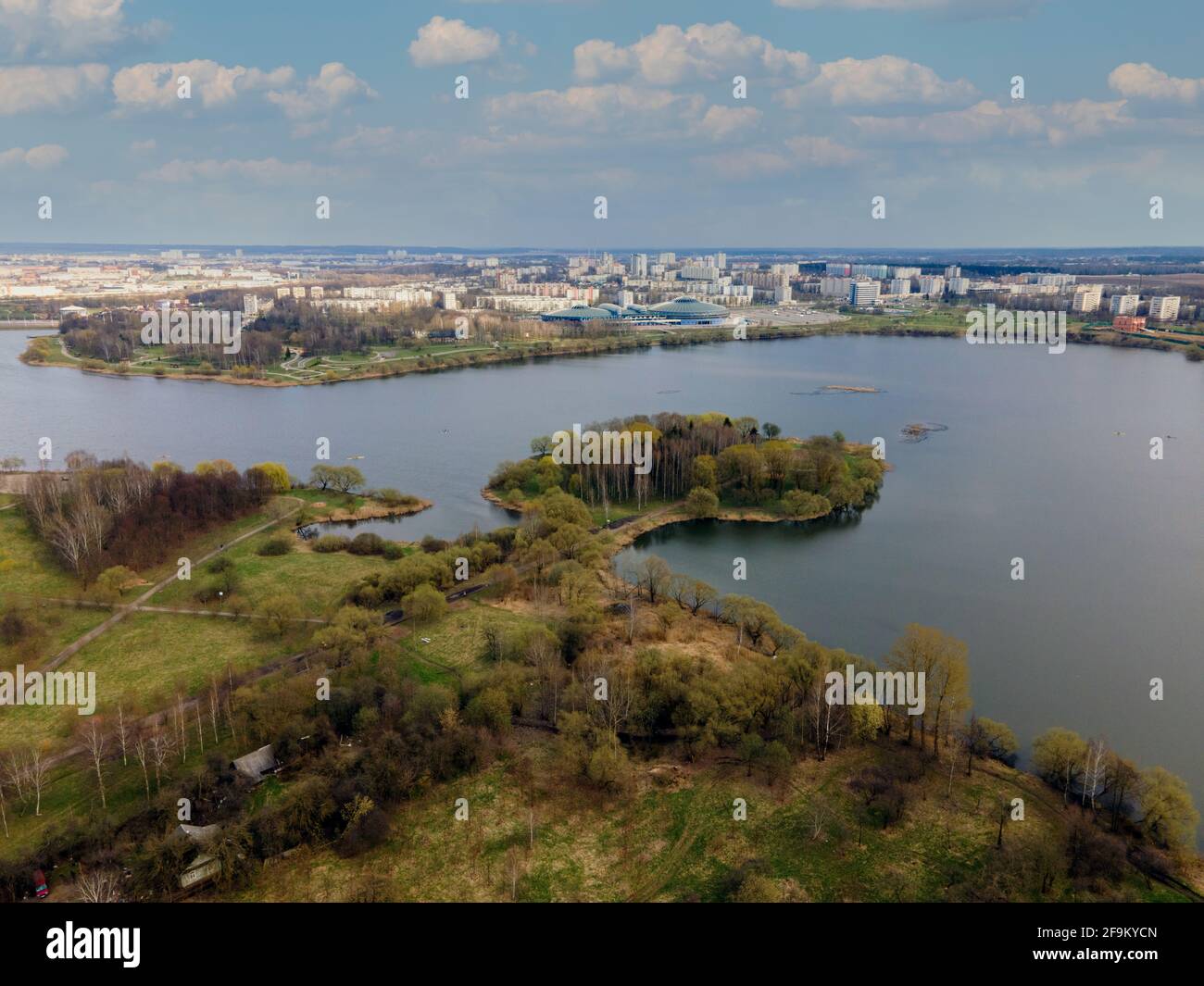 Aerial photography of the spring city park. Park alleys and a reservoir ...