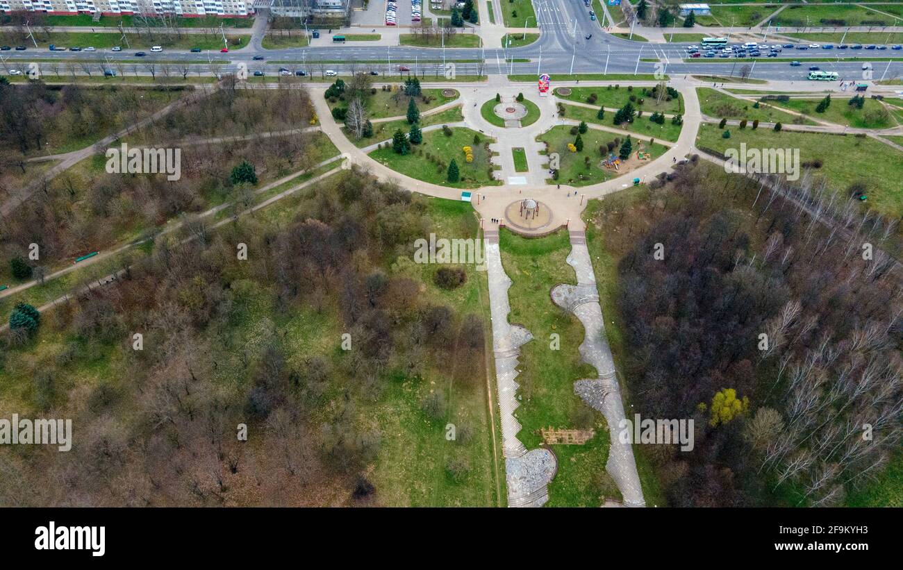 Aerial photography of the spring city park. Park alleys and a reservoir ...