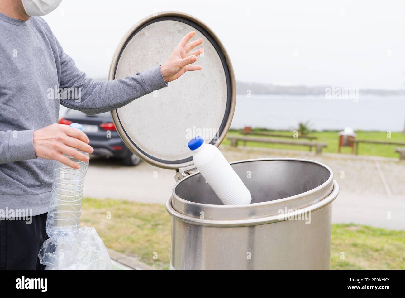 Man throwing plastic containers at plastic recycling point. Social ...