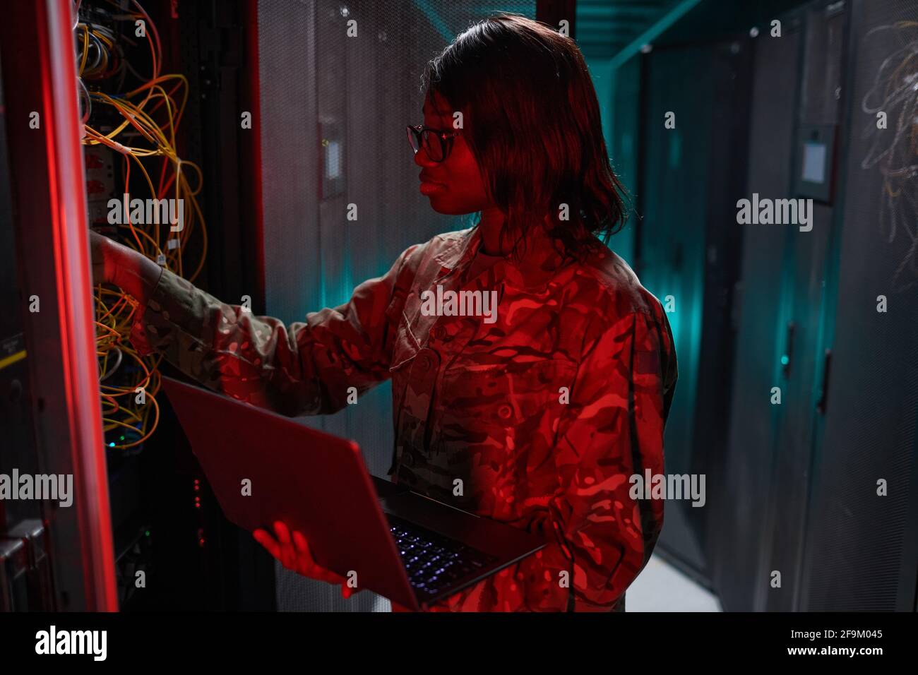 Side view portrait of African-American woman managing computer network ...