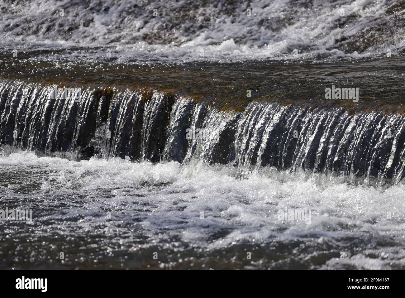 Water cascades as it flows along Scalby Beck and out into the North Sea ...