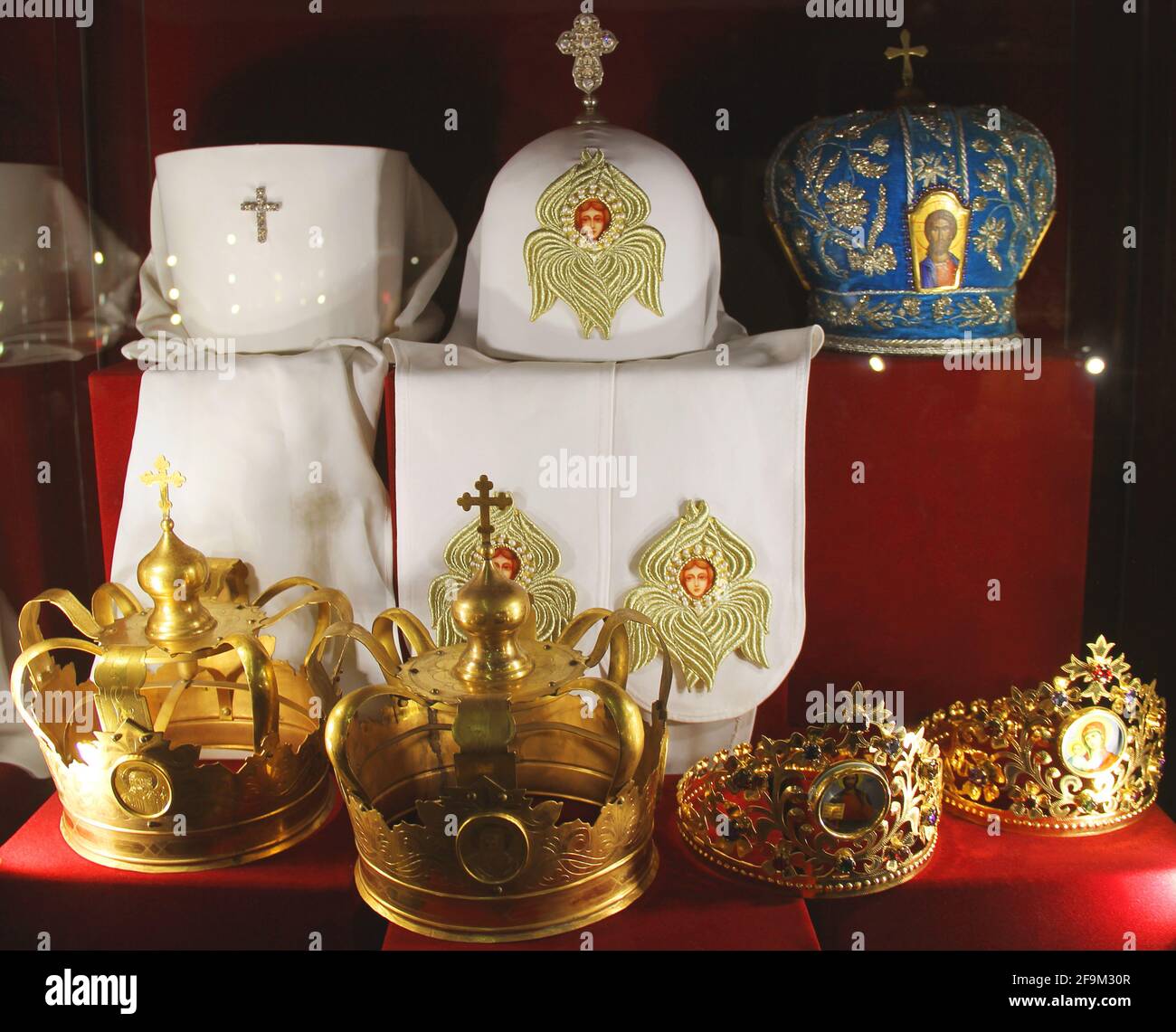 Crown and priests hats on a red background Stock Photo - Alamy
