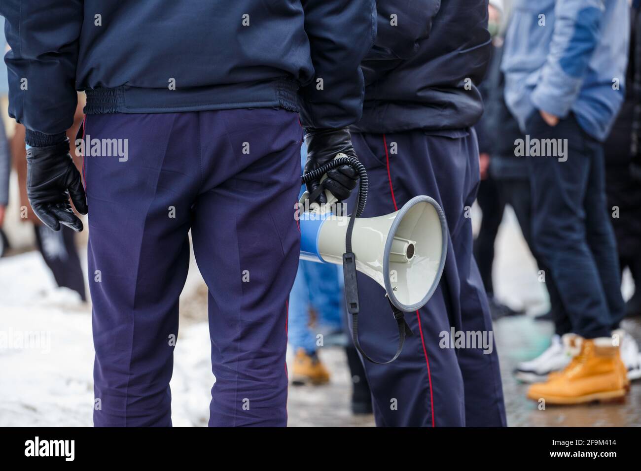 police officer holding loudspeaker megaphone at daylight, close-up with ...