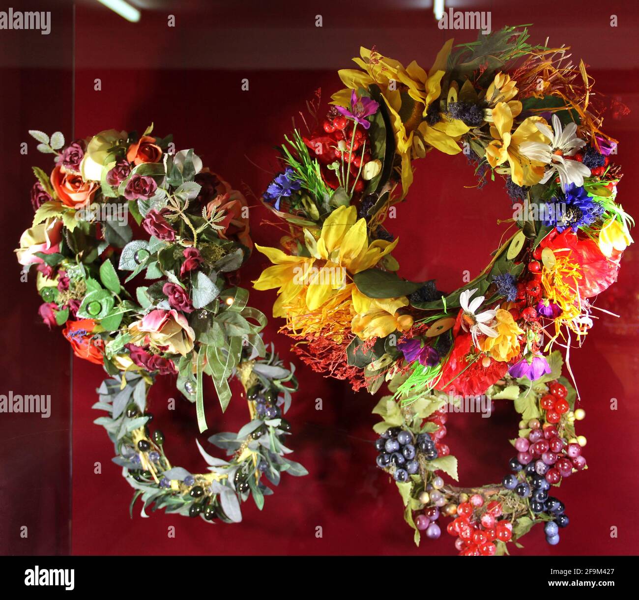Wreaths with flowers and fruits on a red background Stock Photo - Alamy