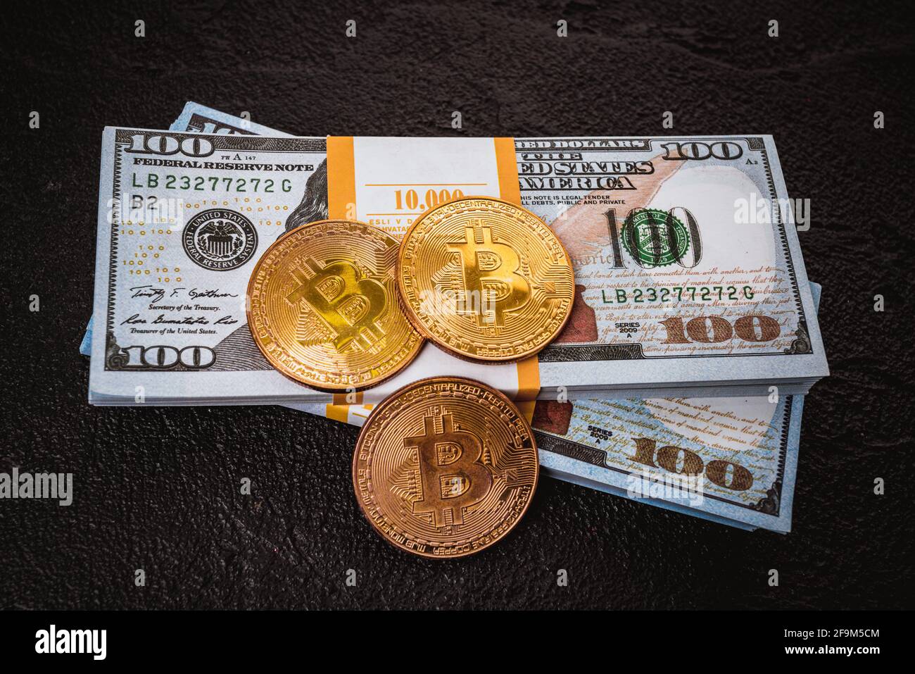 golden bitcoin metal coin on one US dollar bill Stock Photo - Alamy