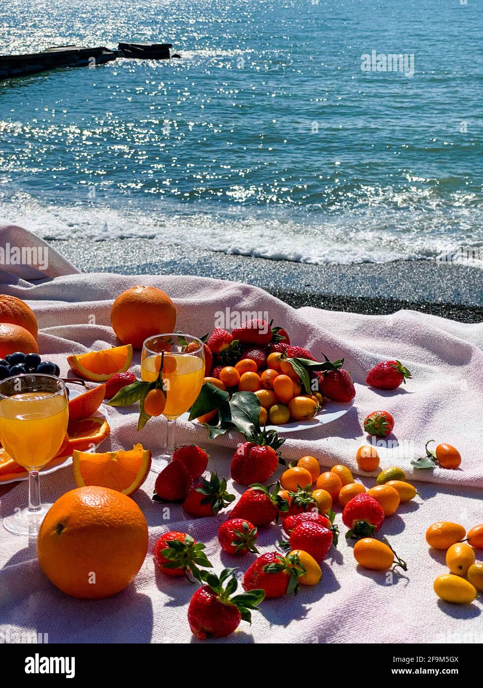 fresh fruit at the beach. Fruits in the sun. Summer time beach concept ...