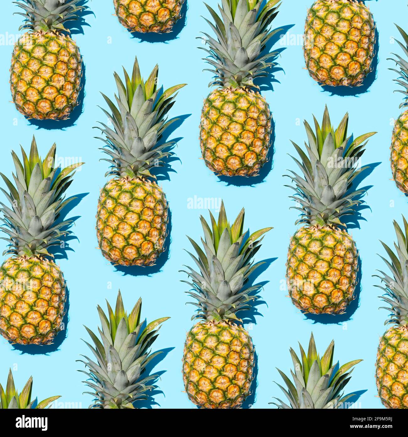 Pineapple pattern on blue background Stock Photo - Alamy