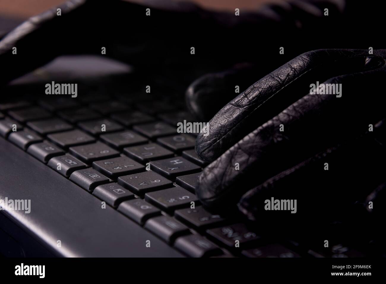 Hacker hands at keyboard gloves hi-res stock photography and images - Alamy