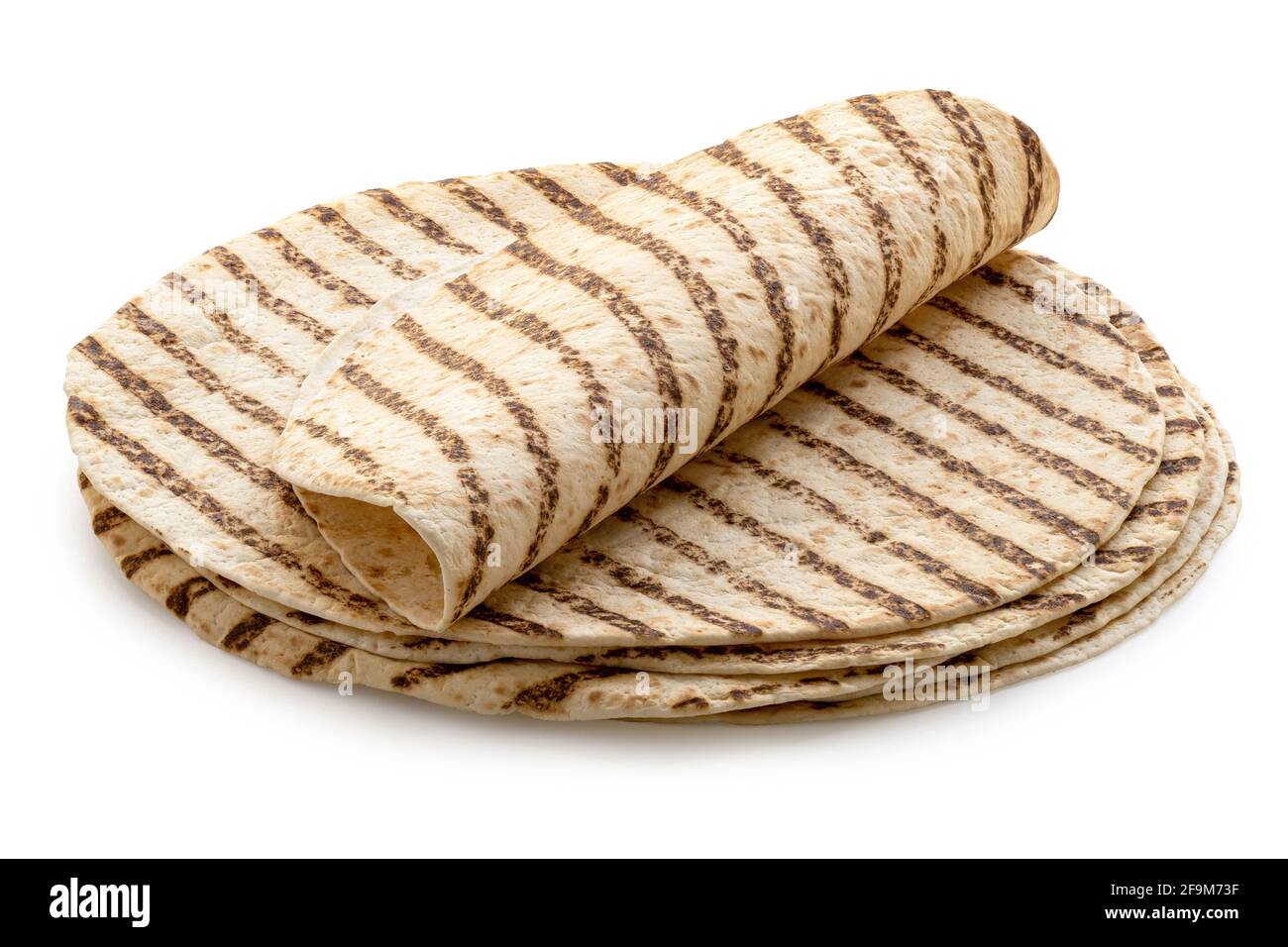 Folded tortilla on top of a stack of plain tortilla wraps with grill ...