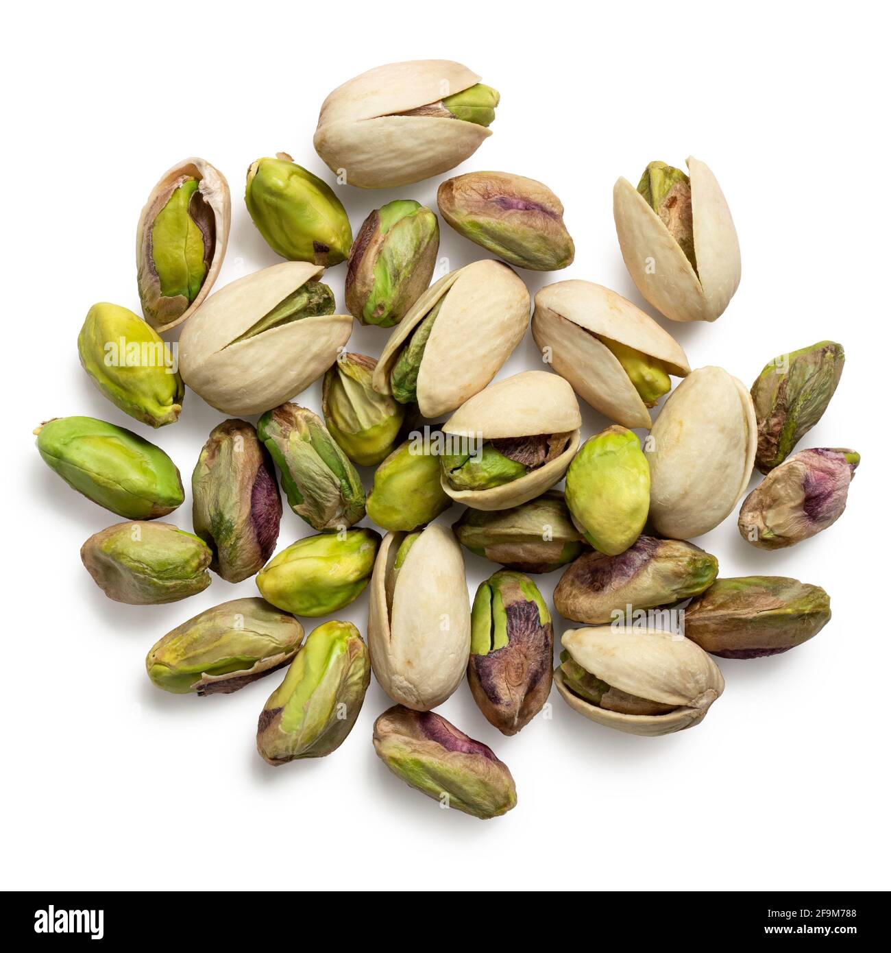 Pile of shelled pistachios and pistachios in shell isolated on white ...