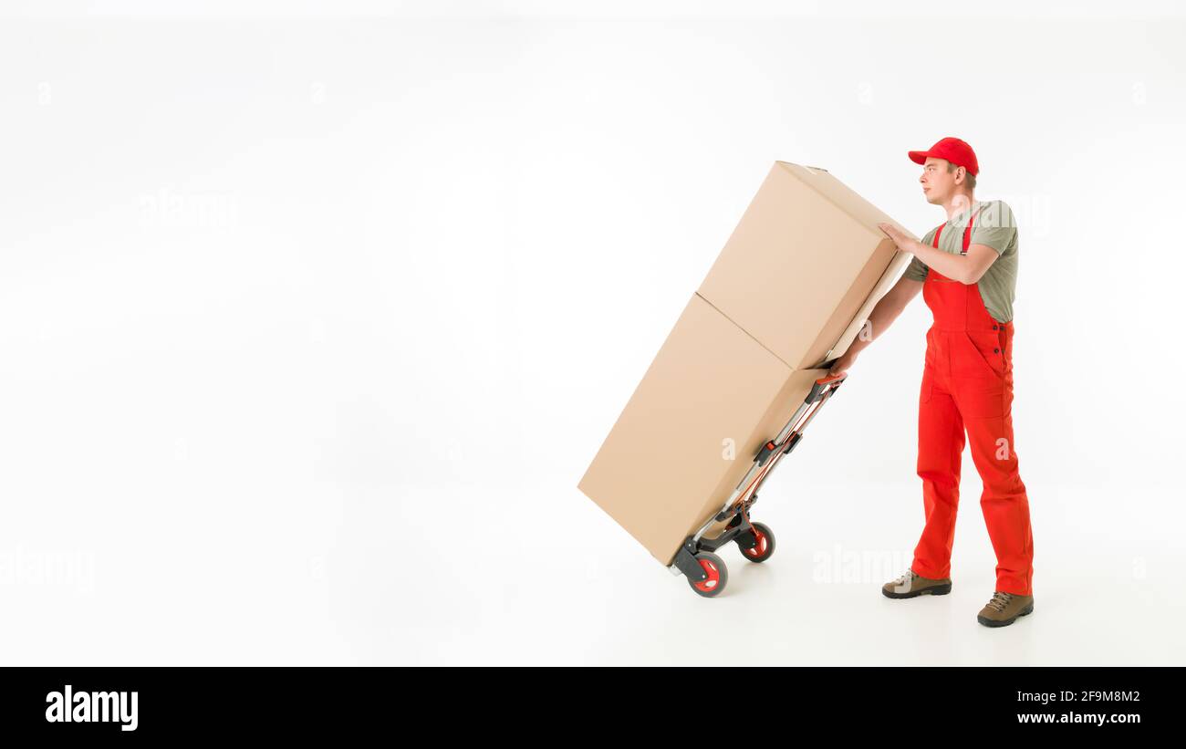 delivery man holding push cart loaded with cardboard boxes, on white ...