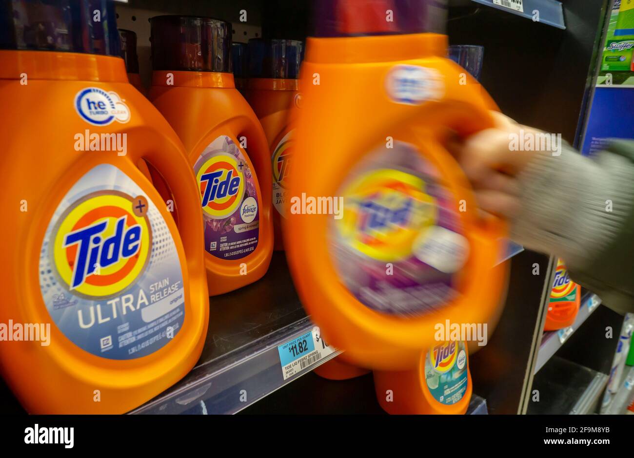 A shopper grabs a container of Procter & Gamble's Tide detergent in a ...