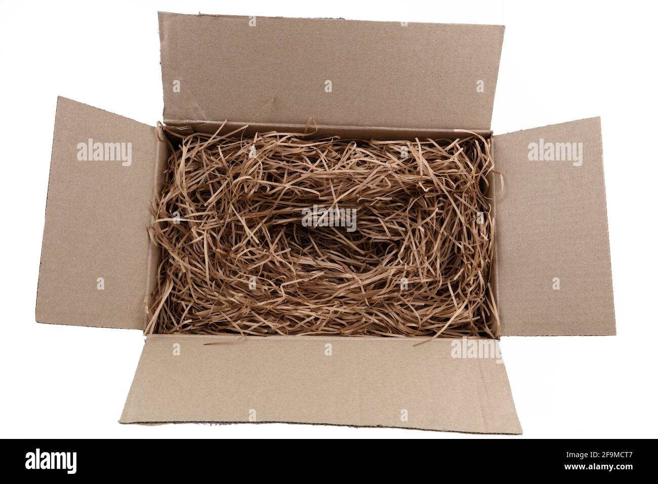 Shredded brown paper packaging in cardboard box Stock Photo - Alamy