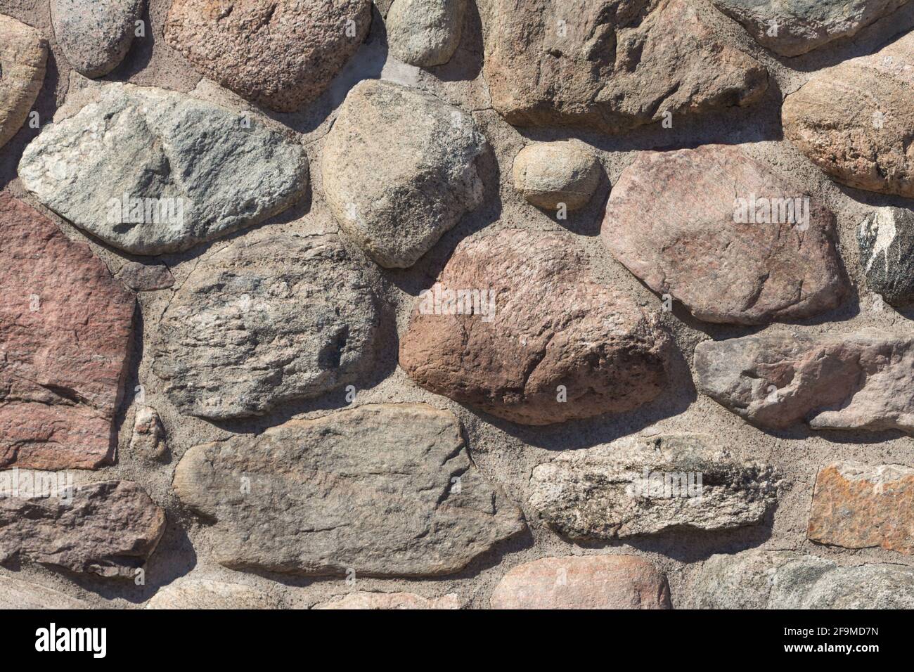 Old stable stone wall with rows of nature masonry stones. Brickwork ...