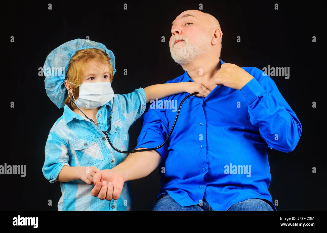 Child with Stethoscope play doctor with grandpa. Kid boy doctor playing ...