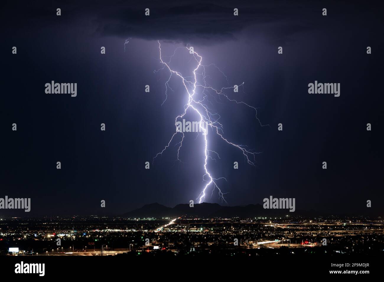 A dramatic lightning bolt strike in a thunderstorm over Phoenix ...