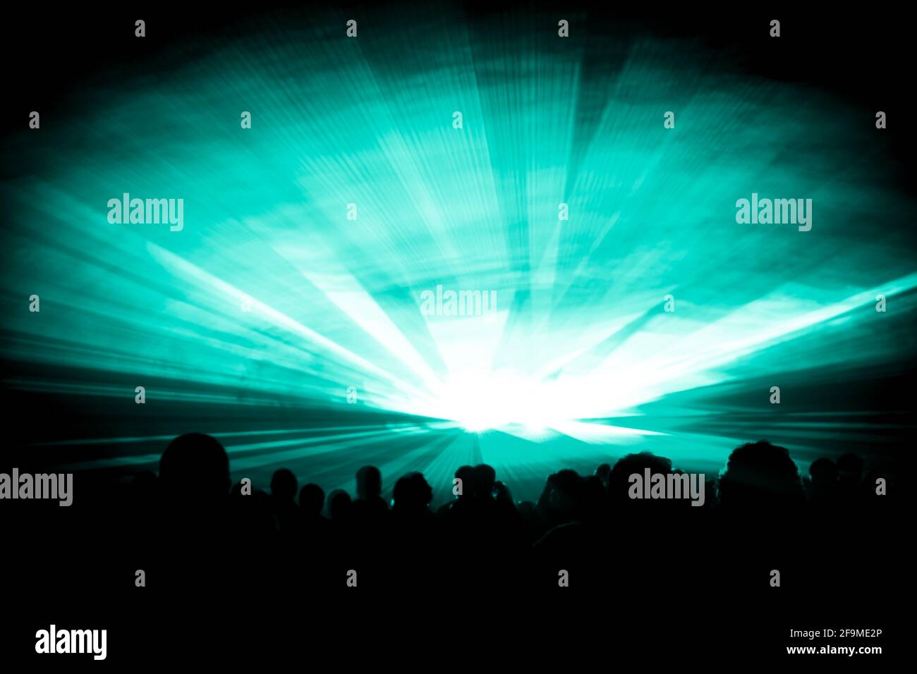 Turquoise laser show nightlife club stage at party people crowd. Luxury ...