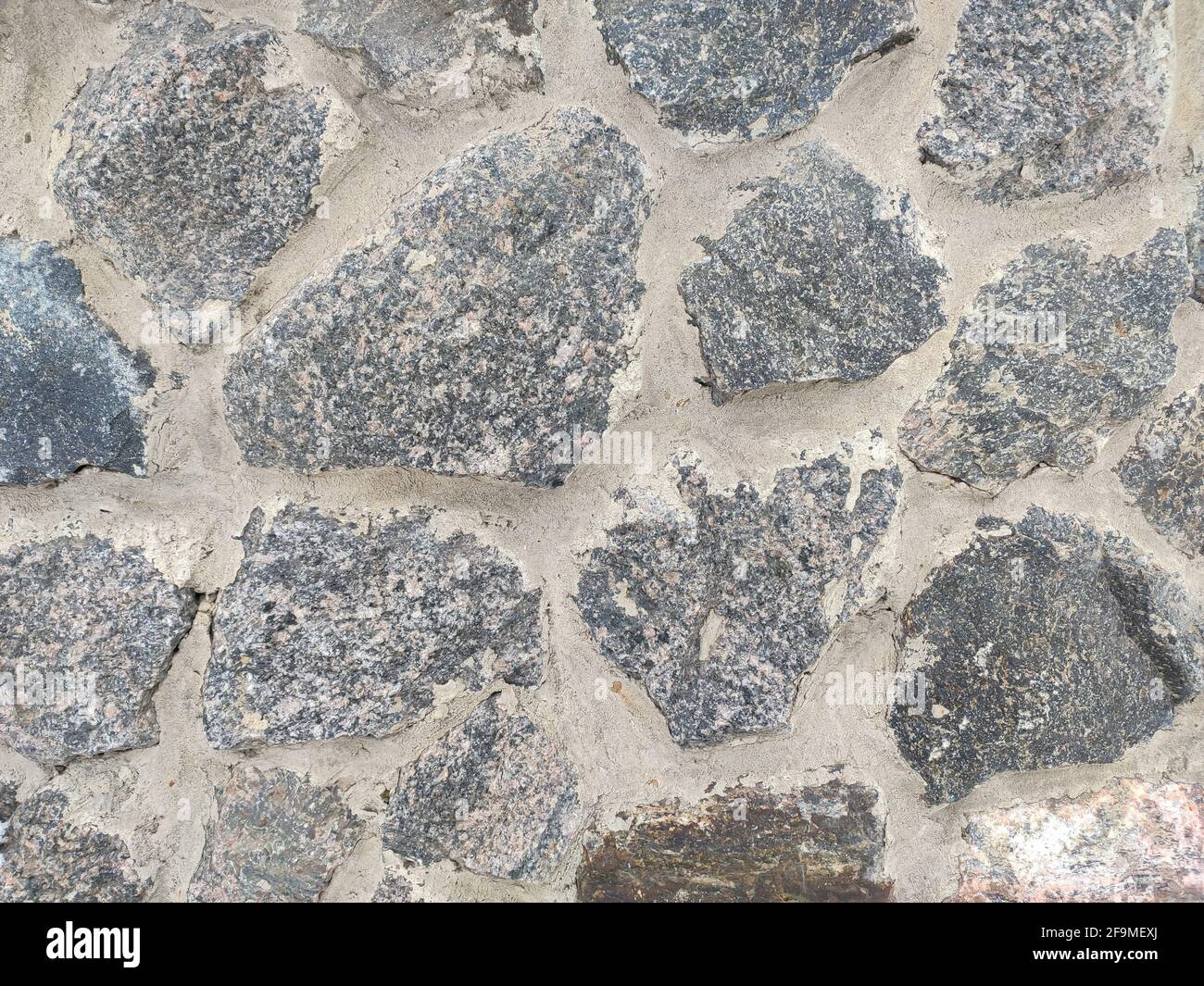 A wall of rough stones. Stone wall texture. Stone wall as background ...
