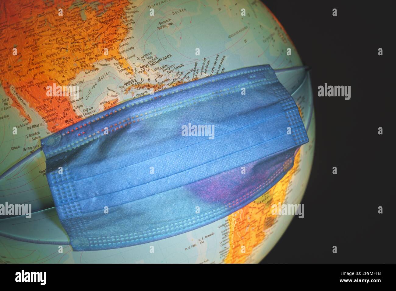 Illuminated globe showing USA and Latin America with blue medical face ...