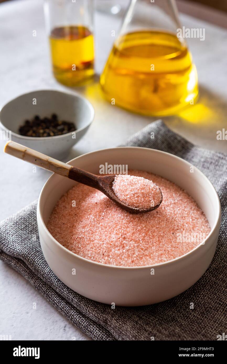 Photograph of grains of Himalayan salt accompanied by pepper and olive ...