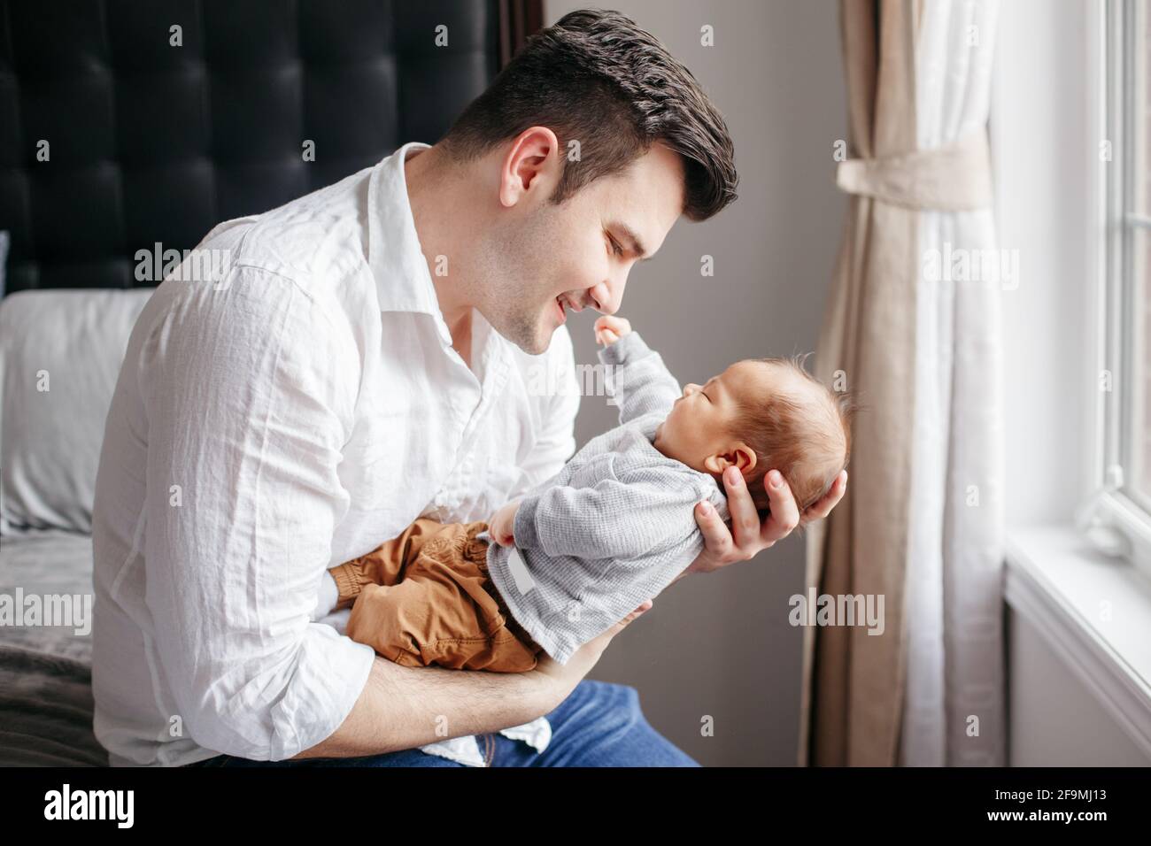 Father's day holiday. Happy young dad holding newborn baby boy Stock ...