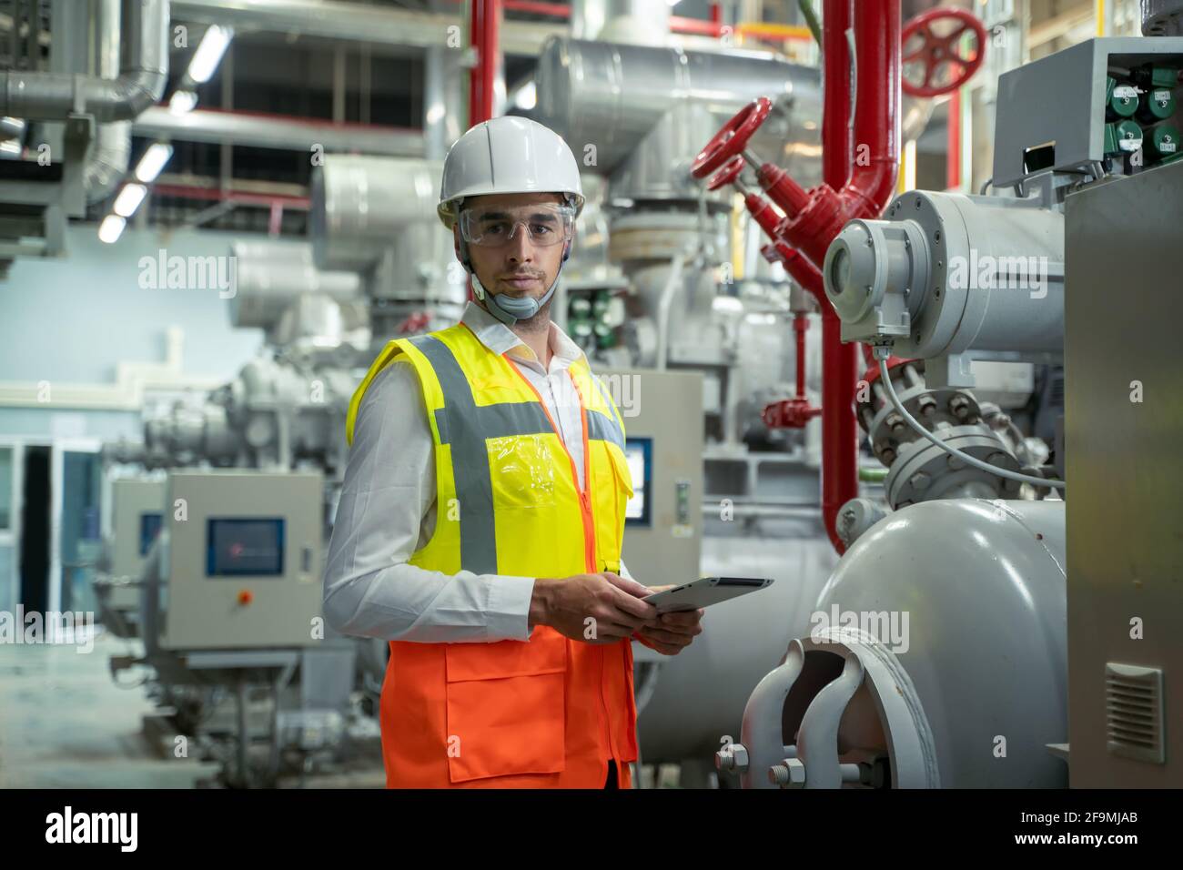 Mechanical Maintenance Technician Inspecting Pressure Gauge Of H Stock mechanical-maintenance-technician-inspecting-pressure-gauge-of-h-stock