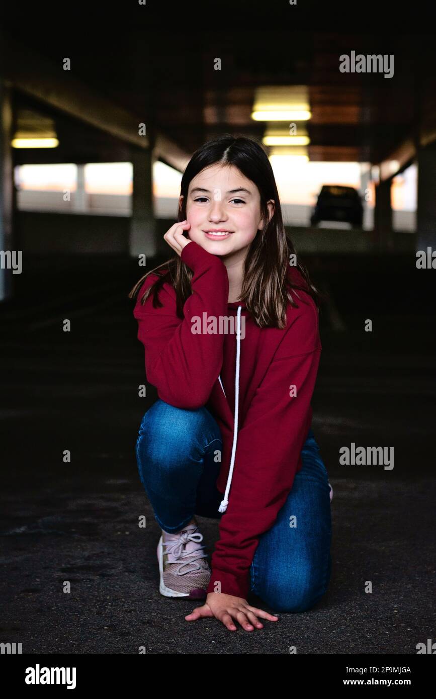 Beautiful tween girl with long dark hair smiling in the city Stock ...