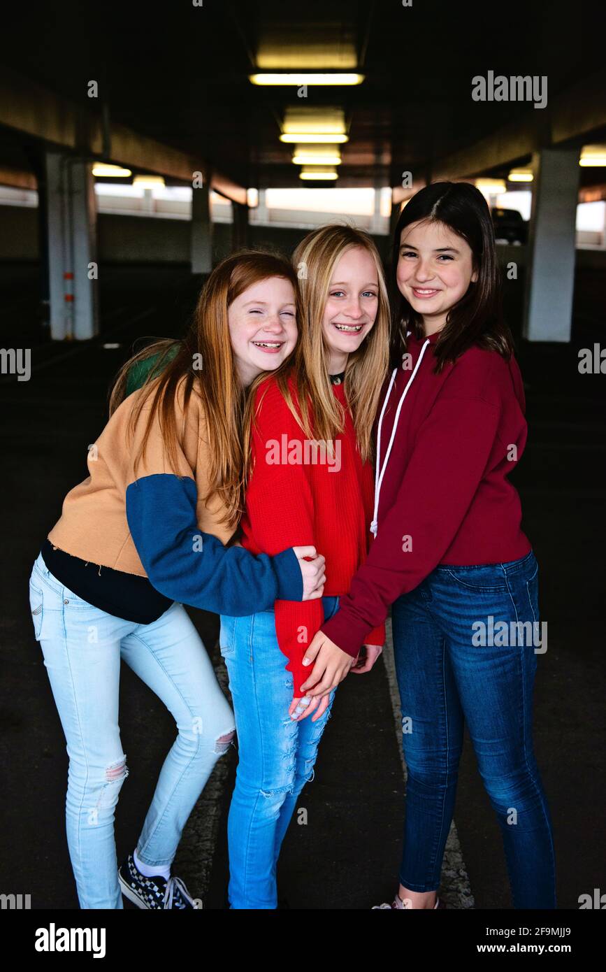 Three cute tween girls laughing together Stock Photo - Alamy