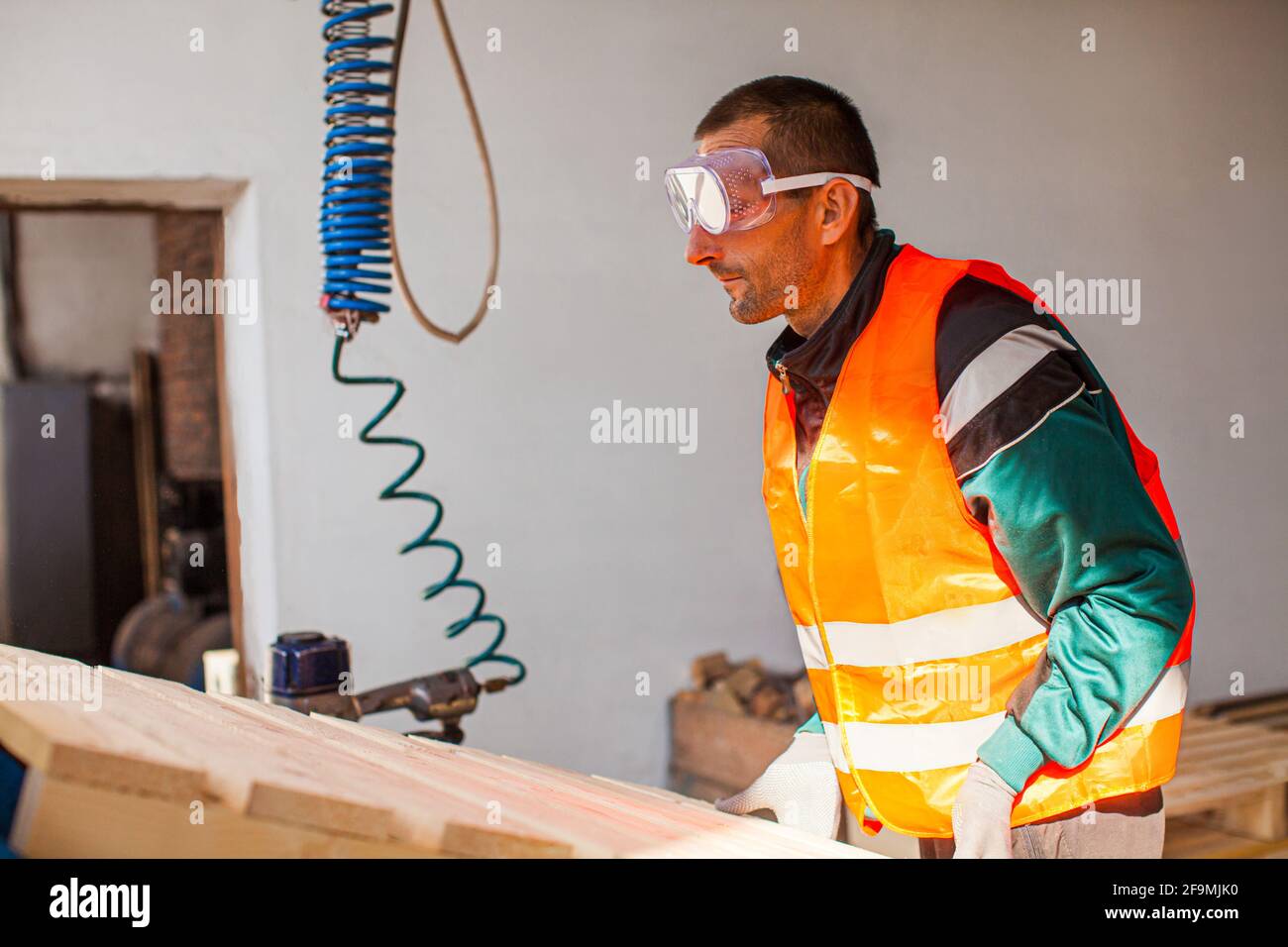 Carpenter man at woodworking factory working place Stock Photo - Alamy