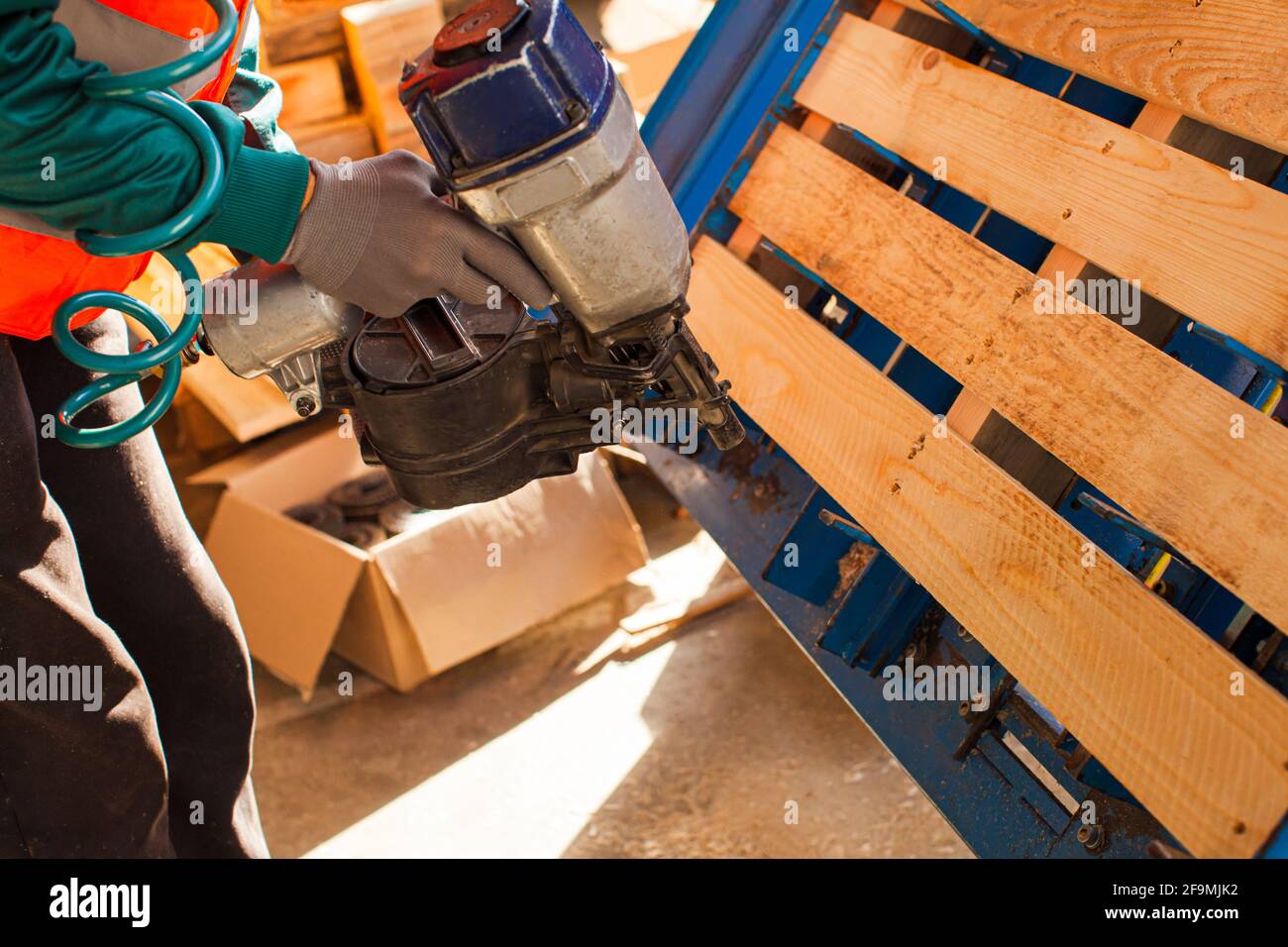 Professional furniture production factrory worker using pneumatic ...