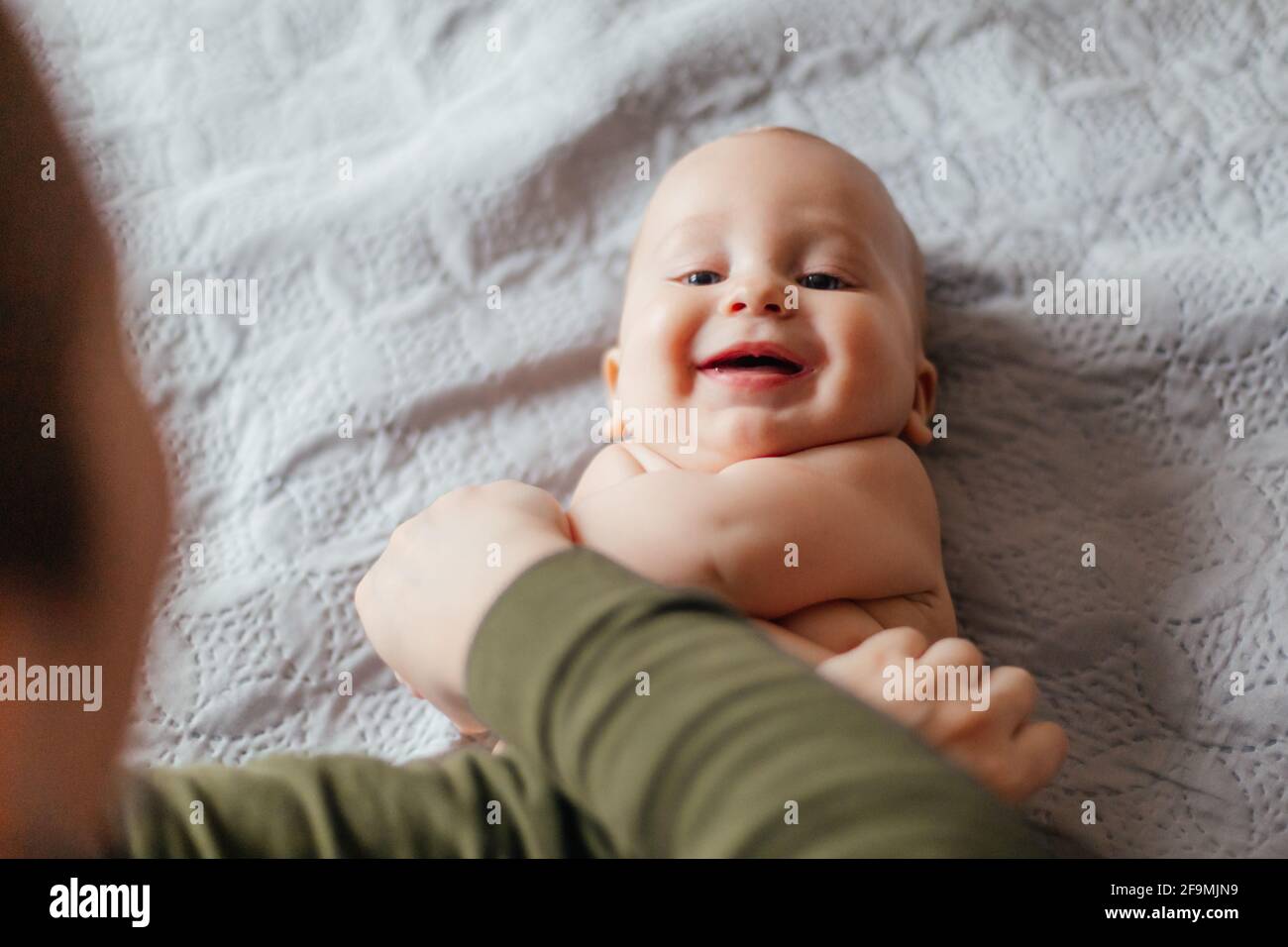 Doing daily routine physical exercises with newborn baby Stock Photo ...