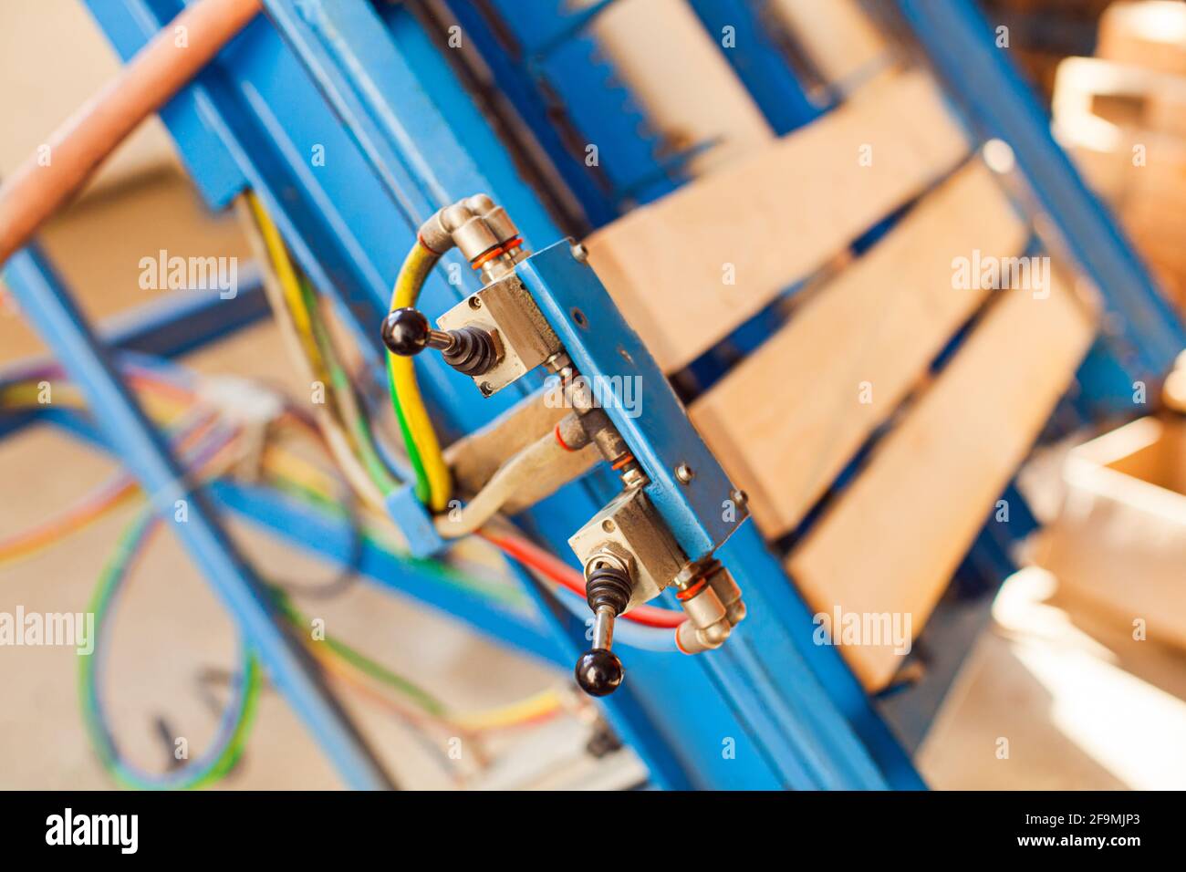Control switch on toggle as a part of machinery at woodwork factory ...